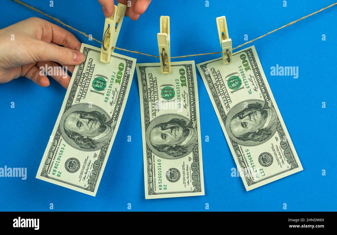 Hands and money laundering. Illegal financial business concept, dollar ...