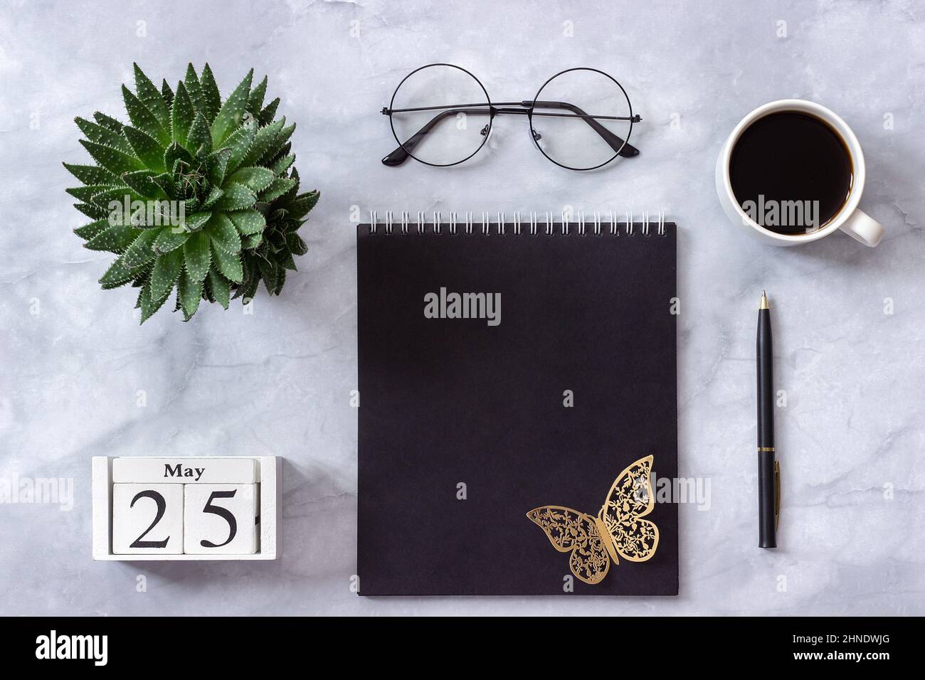 Office or home table desk. Wooden cubes calendar May 25. Black notepad ...