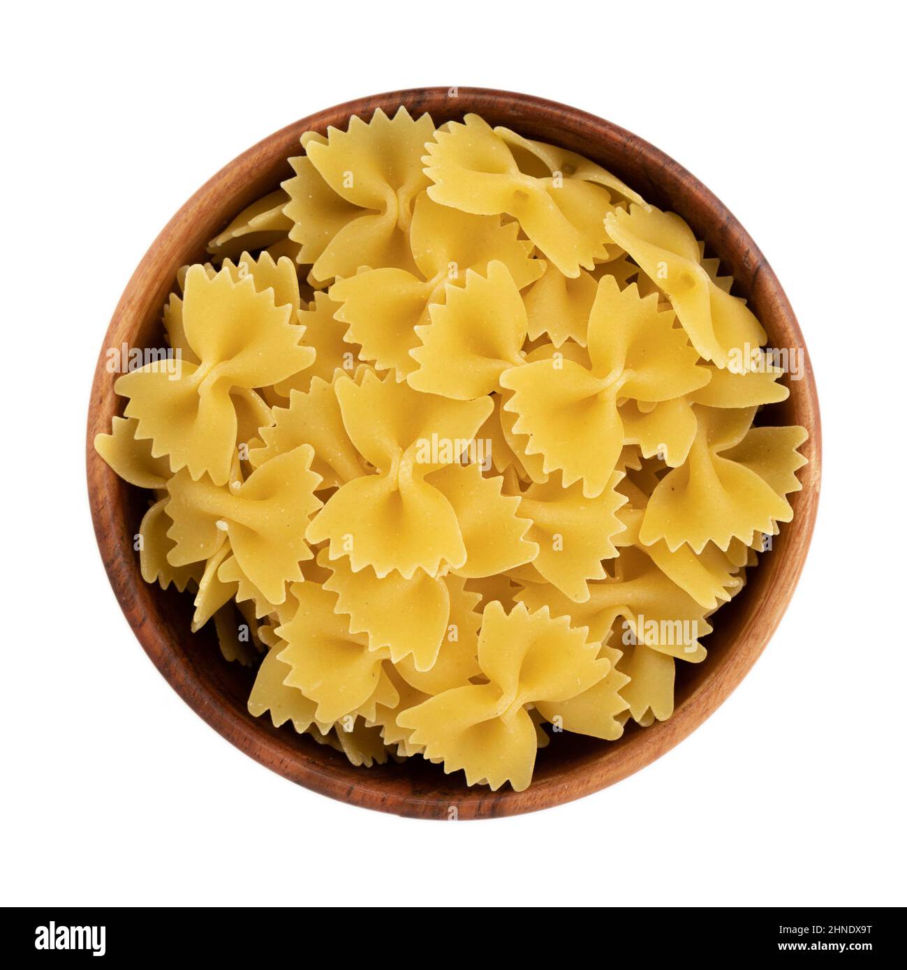 pasta farfalle in wooden bowl isolated on white background, raw pasta ...