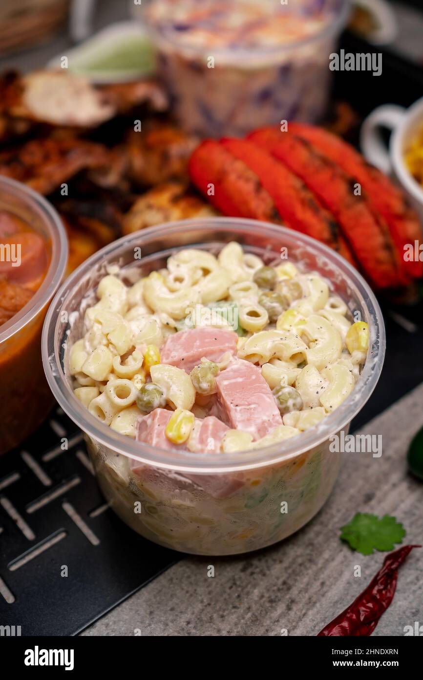 Macaroni salad in a transparent plastic bowl Stock Photo - Alamy