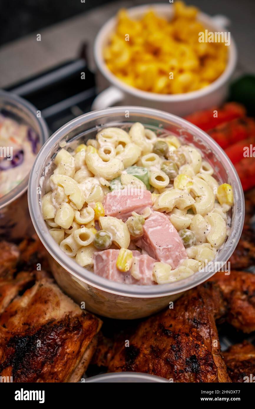 A macaroni salad in a transparent plastic bowl Stock Photo - Alamy