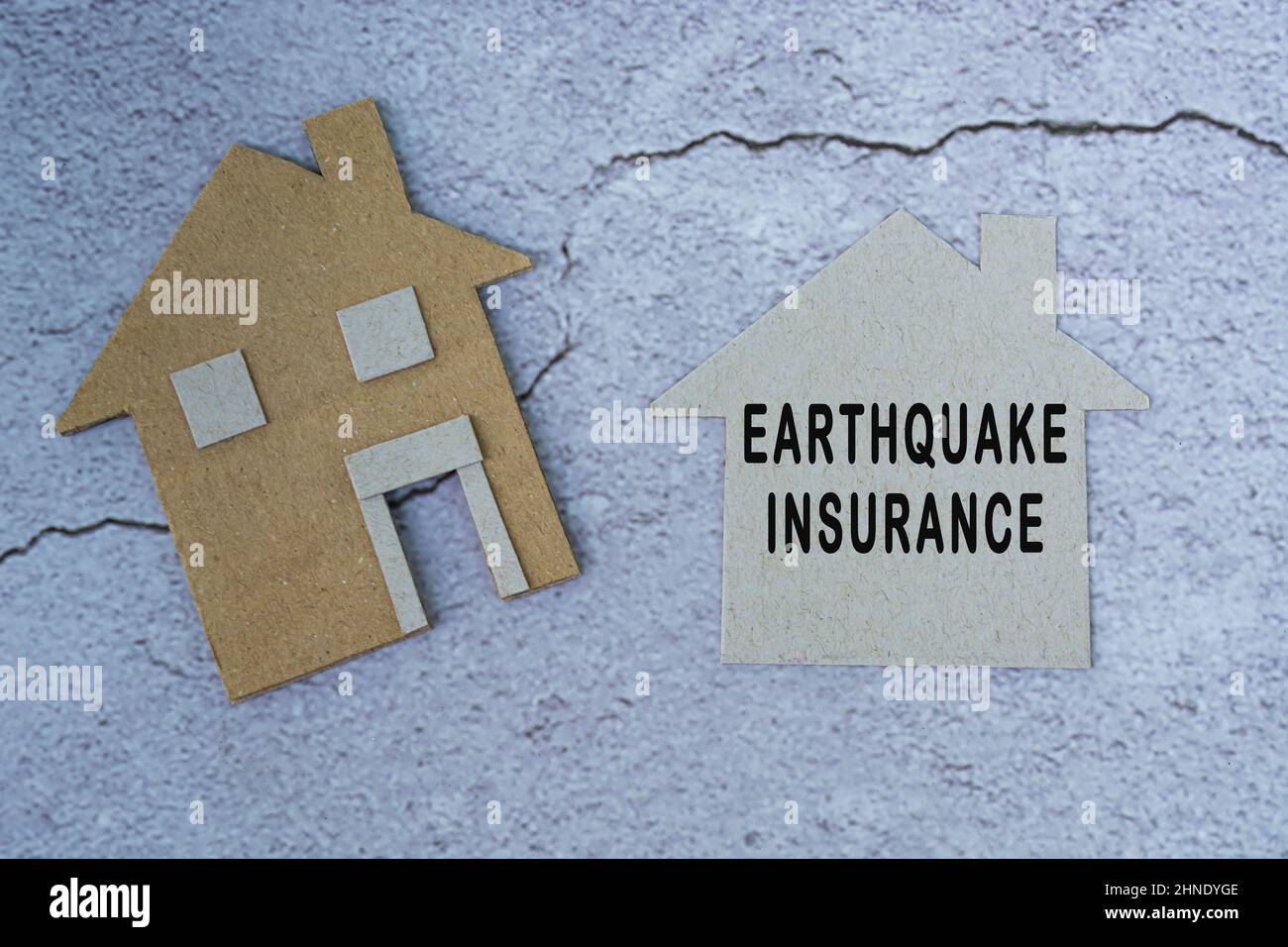 Earthquake insurance text on paper house model. Home insurance concept ...