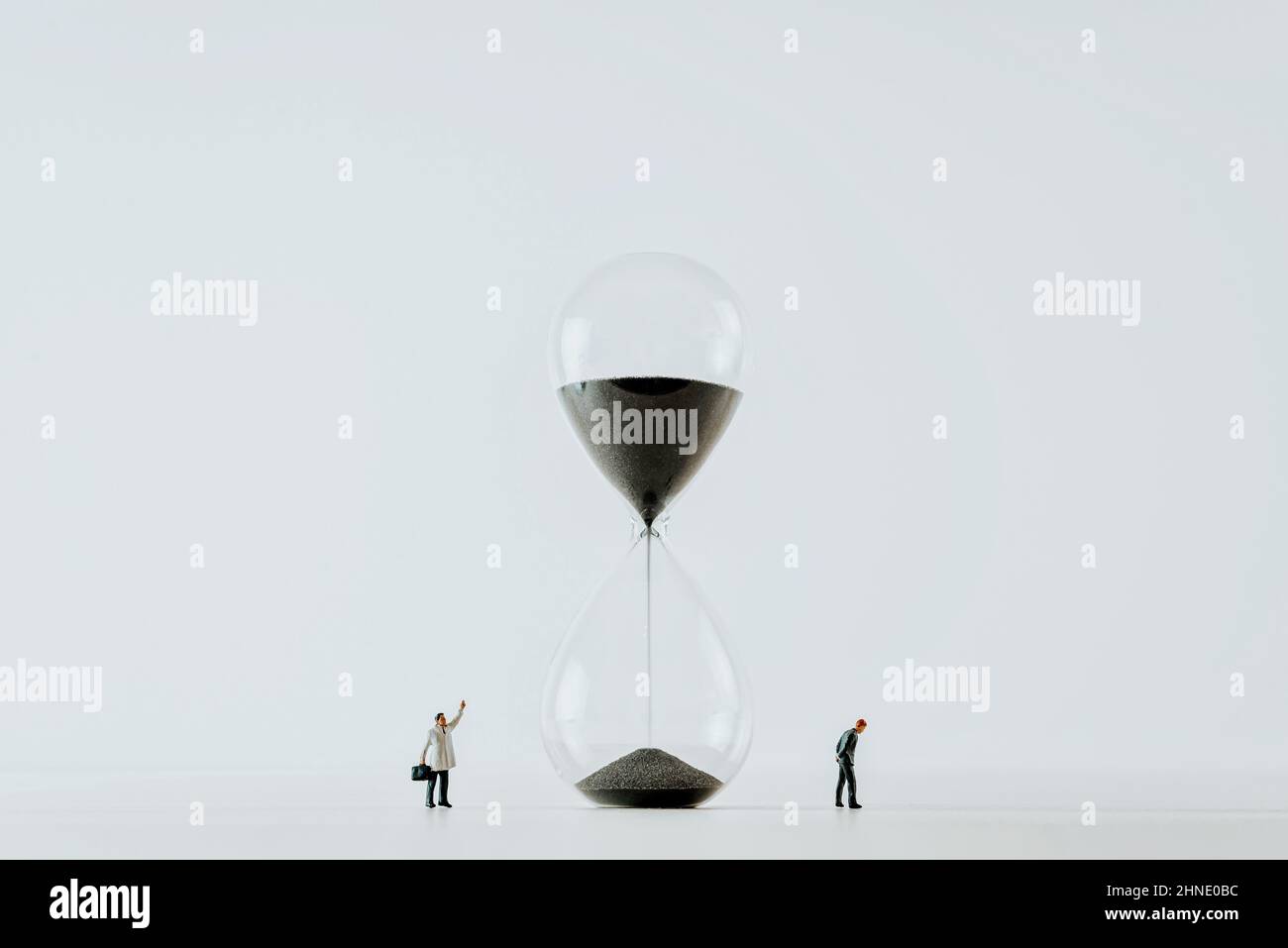 Business people looking at Hourglass. Time management concept Stock ...