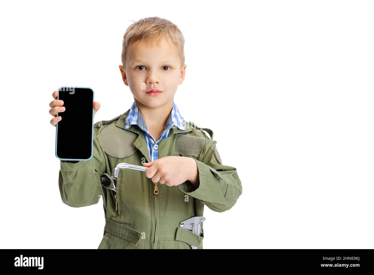 Happy little boy, cute kid in image of auto mechanic or fitter in green ...