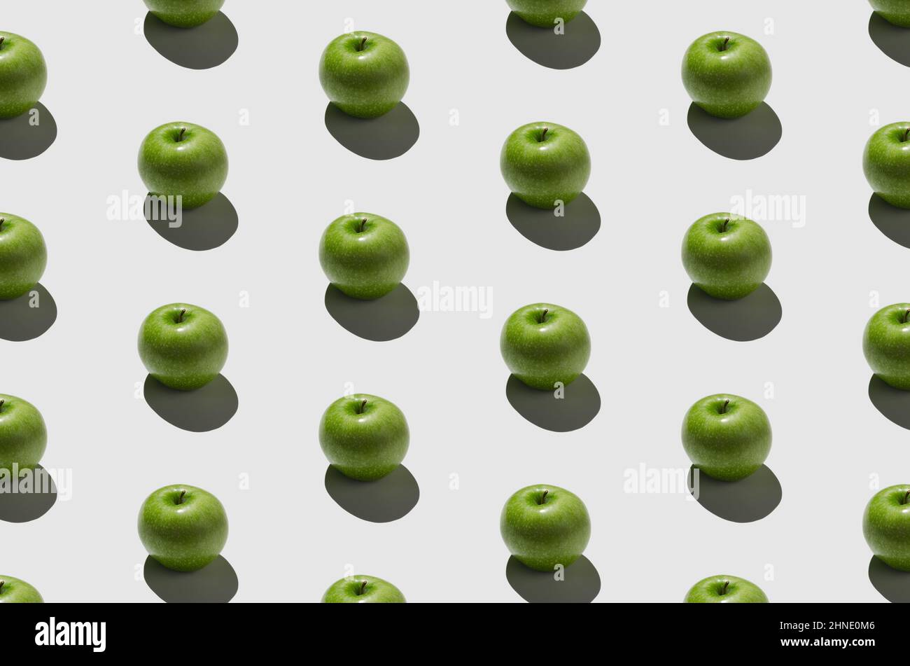 Green apple pattern on a white background. Hard shadows Stock Photo - Alamy