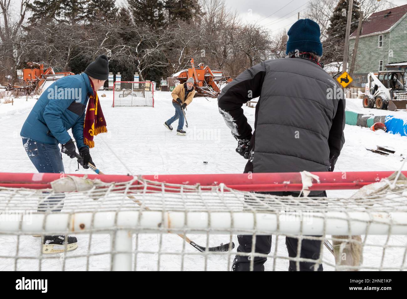 Detroit, Michigan - Older men play ice hockey on a makeshift back yard ...