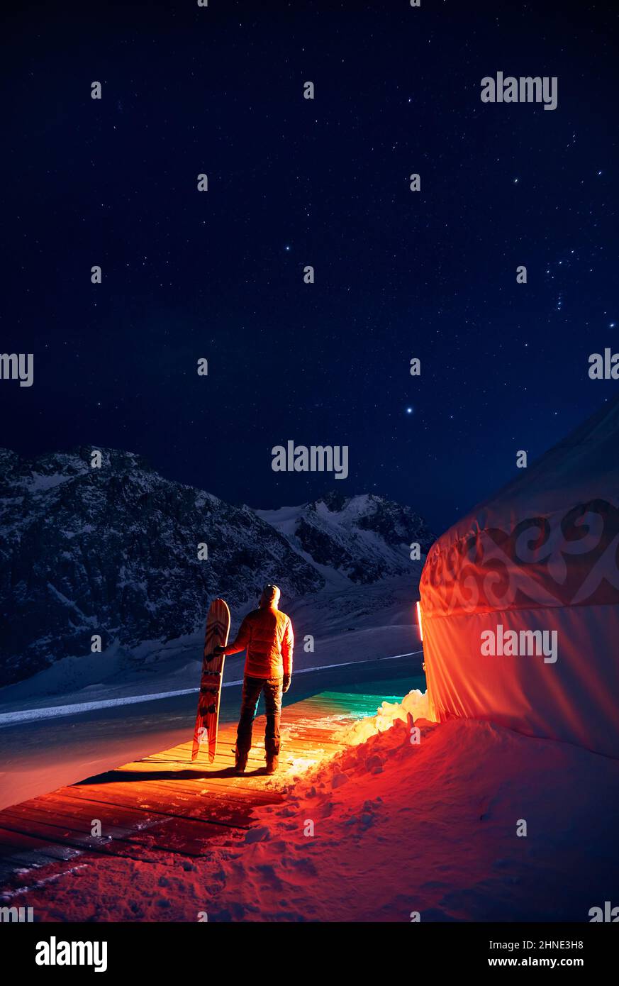 Man holding split snow board near Yurt nomadic house complex at Ski ...