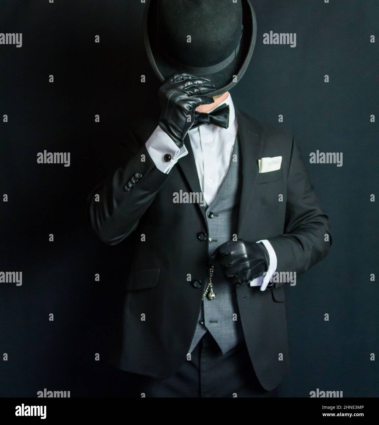 Gentleman in Dark Suit and Leather Gloves Doffing Bowler Hat. Vintage ...
