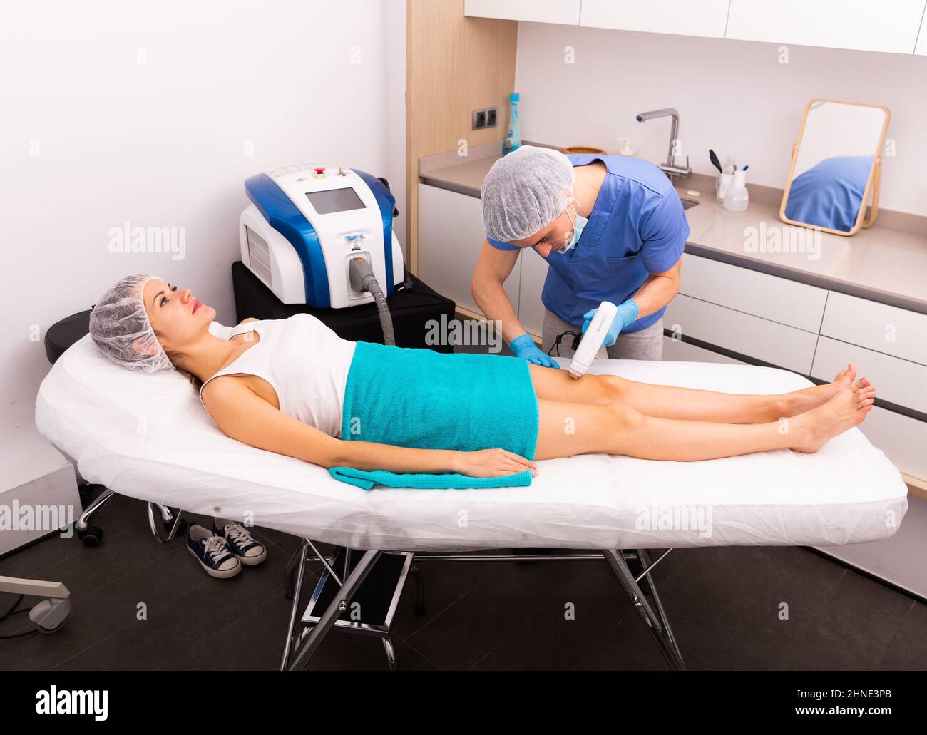 Woman getting professional laser hi-res stock photography and images ...