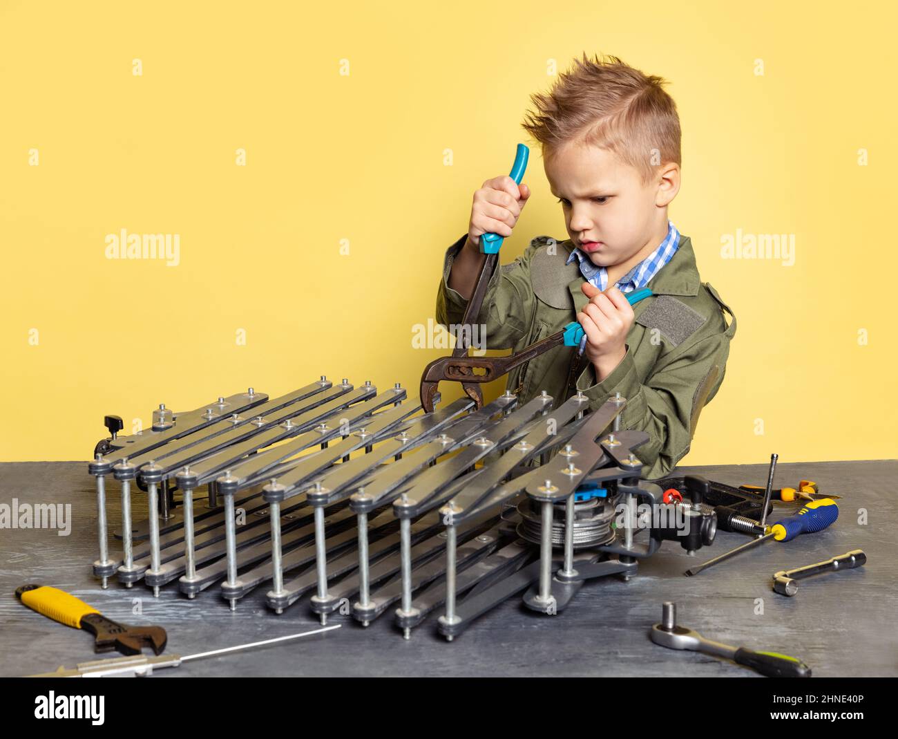 Cute little boy, child in image of auto mechanic or fitter in dungarees ...