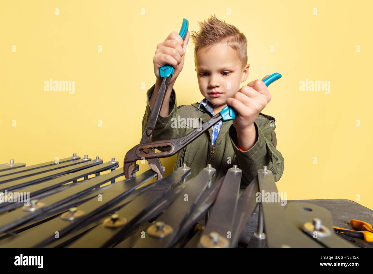 Cute little boy, child in image of auto mechanic or fitter in dungarees ...