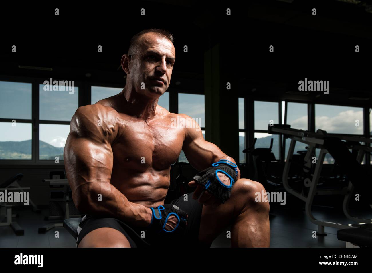 Muscular Man After Exercise Resting In Gym Stock Photo - Alamy