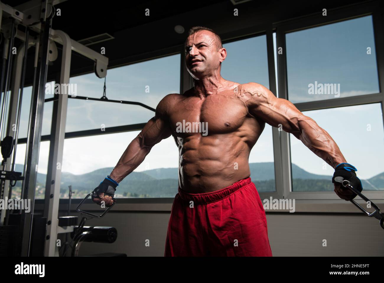 Chest Workout Cable Crossover In Gym Stock Photo - Alamy