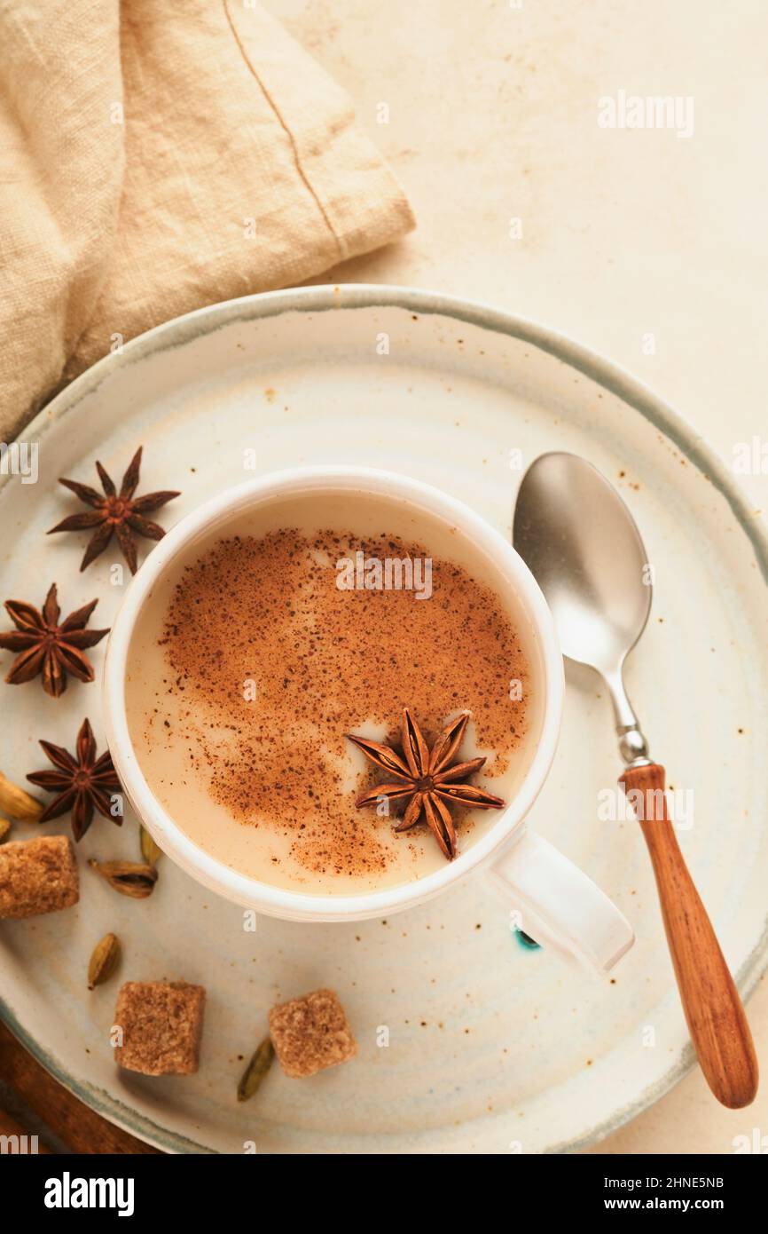 Masala tea. Masala chai spiced tea with milk and spices on light warm ...