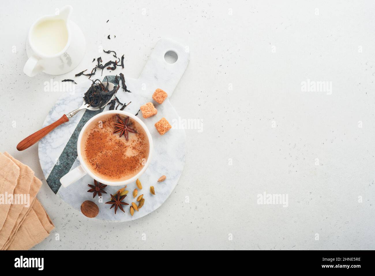 Masala tea. Masala chai spiced tea with milk and spices on light grey ...