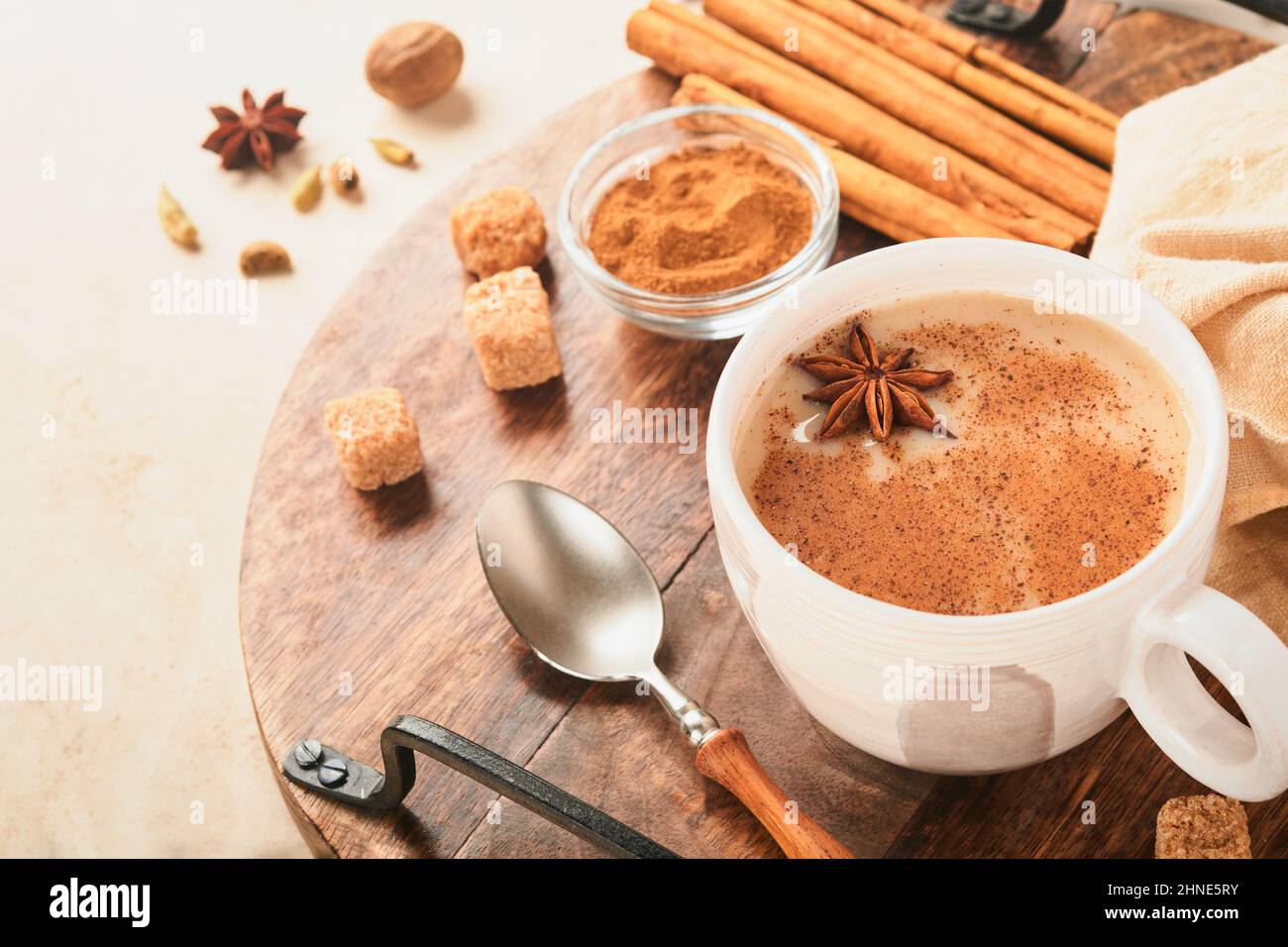 Masala tea. Masala chai spiced tea with milk and spices on light warm ...