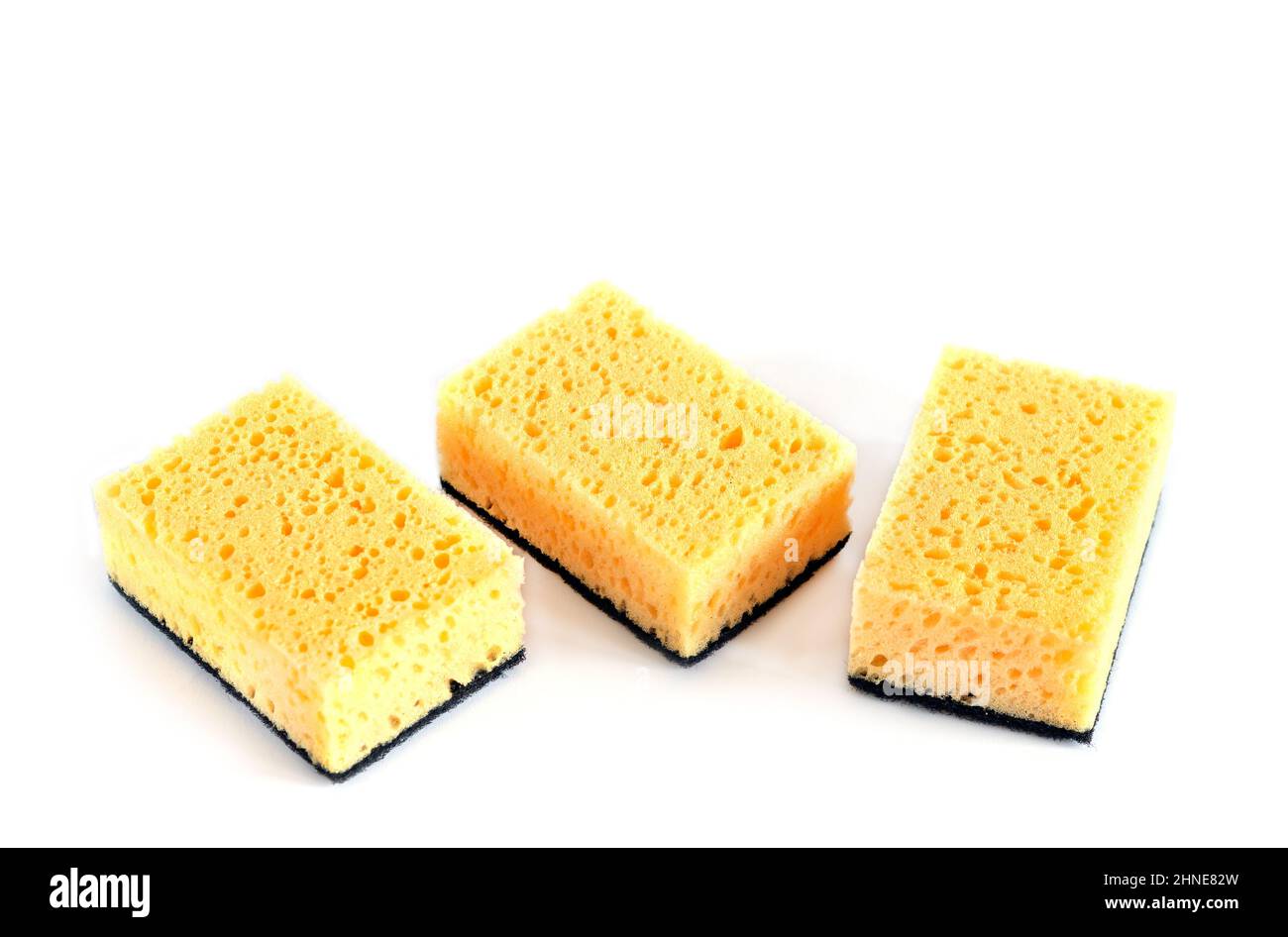 Three yellow sponges for washing dishes and other domestic needs ...