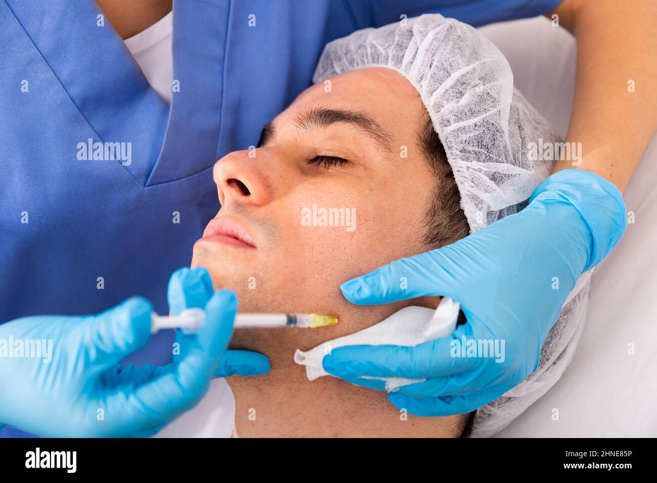 Man getting face injections at aesthetic clinic Stock Photo - Alamy