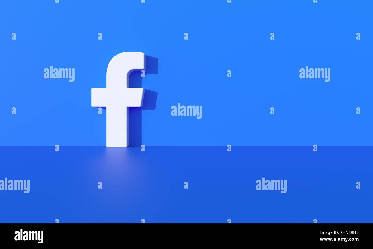 Facebook logo on blue wall background with hard shadow and space for ...