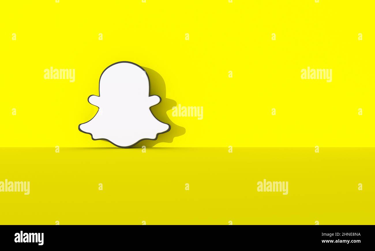 Snapchat logo on yellow wall background with hard shadow and space for ...