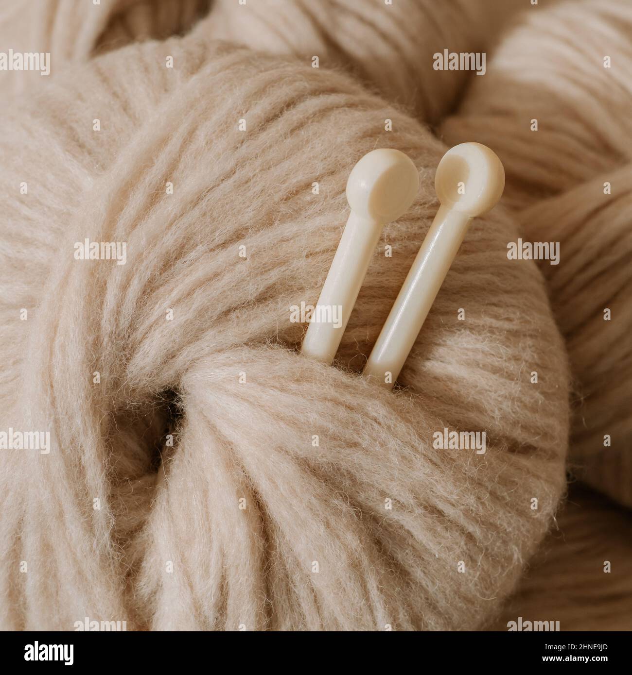 Aesthetic image of pastel beige light, airy yarn skein.Close up view of ...