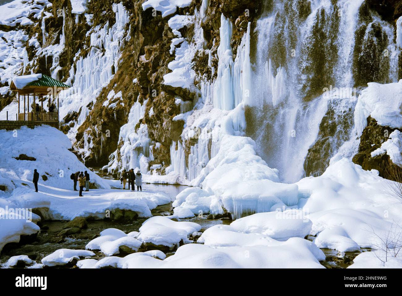 Visitors seen next to partially frozen waterfall in Drung. Drung, a ...