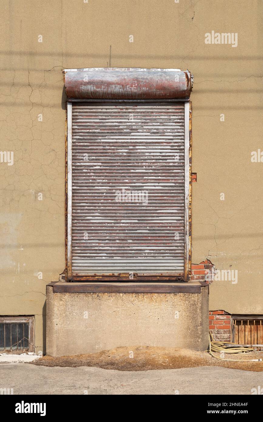 Old rusted door on small loading dock Stock Photo - Alamy