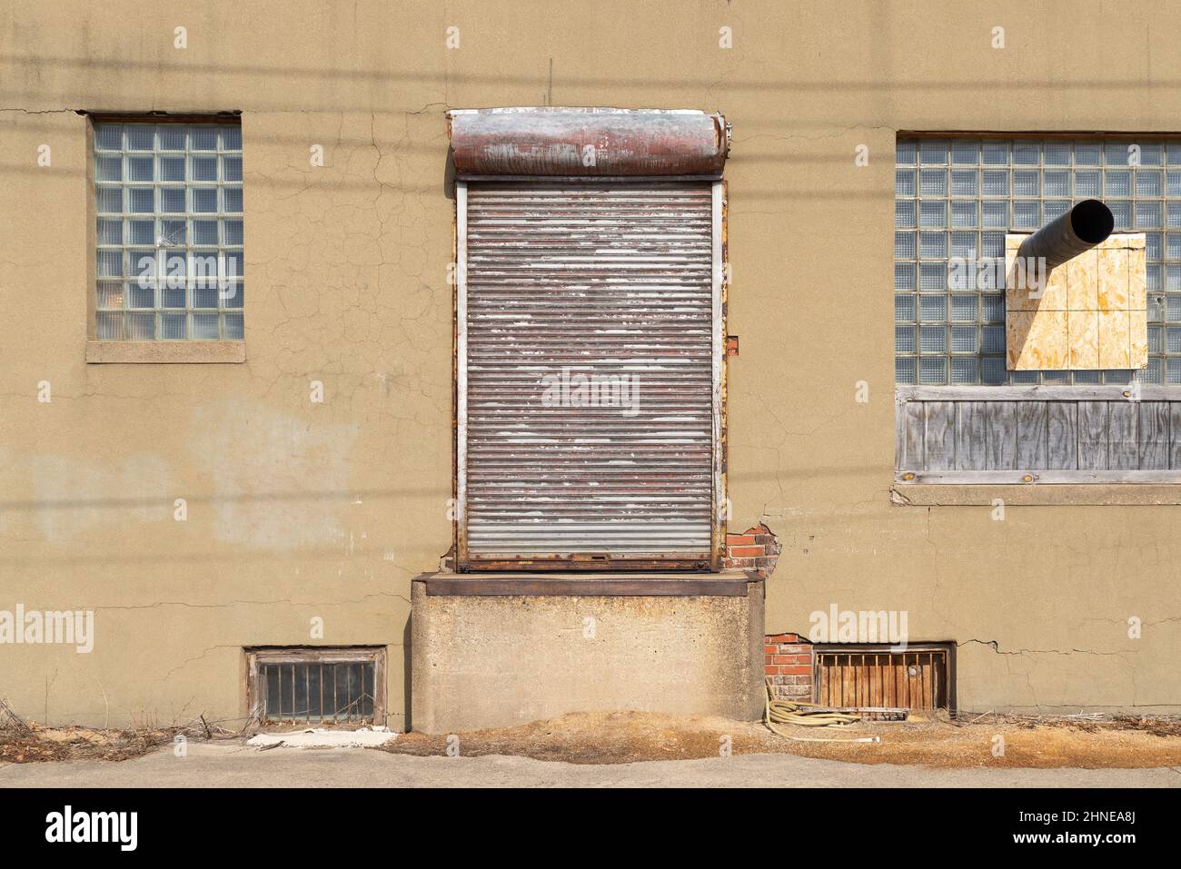 Old rusted door on small loading dock Stock Photo - Alamy