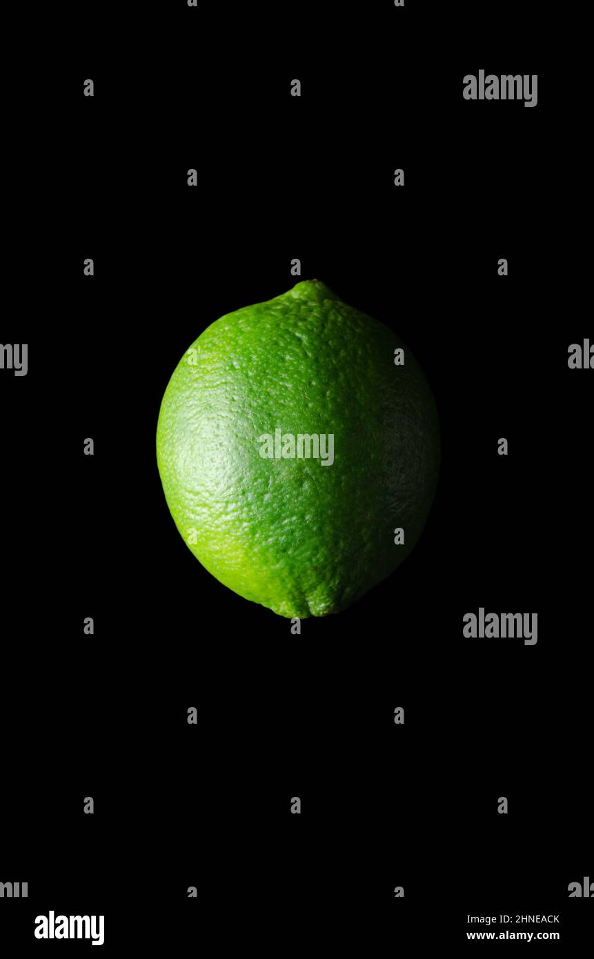 Lime isolated on black background Stock Photo - Alamy
