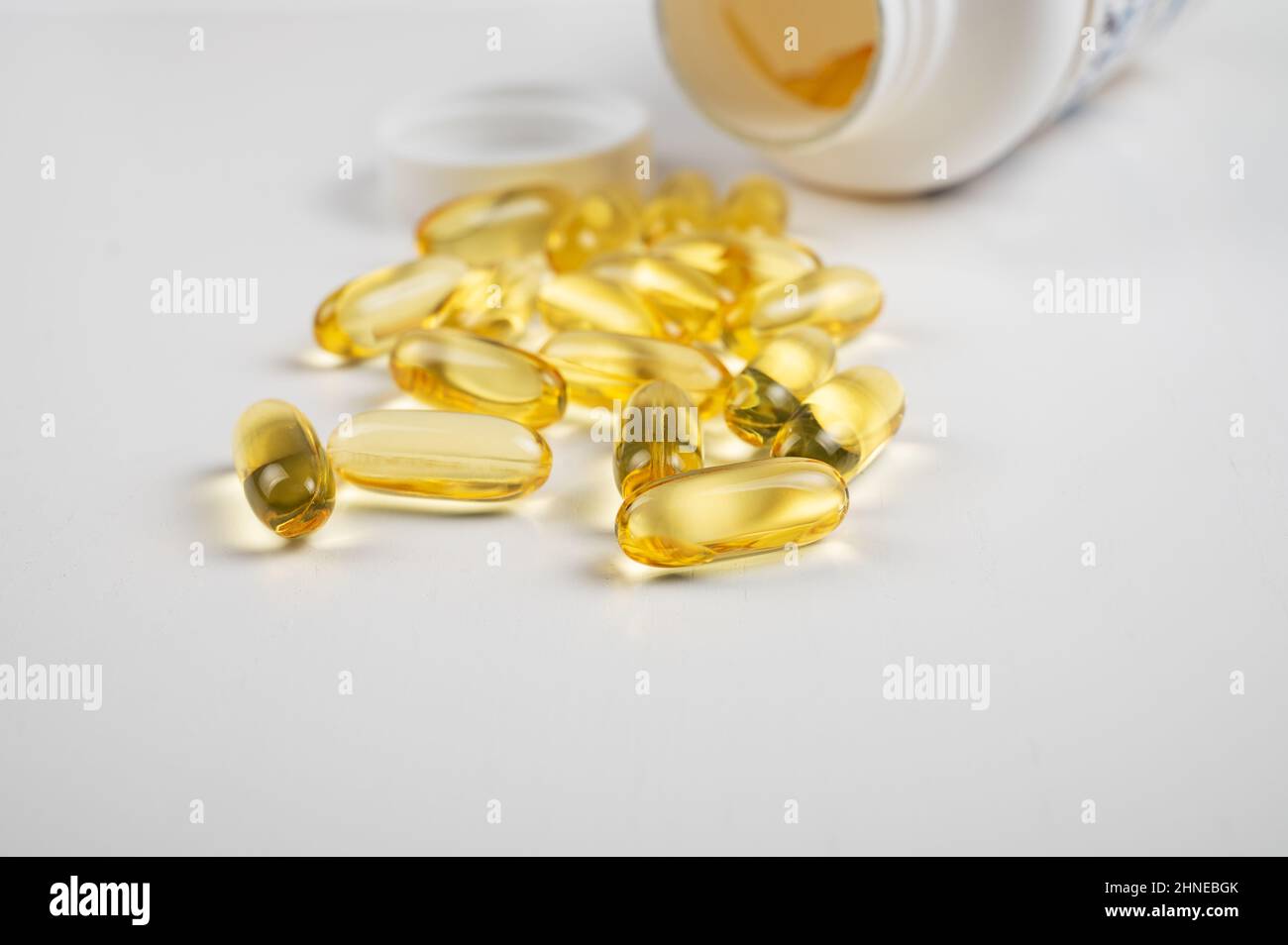 Gold fish oil isolated on white background. Pile of fish oil with Omega ...