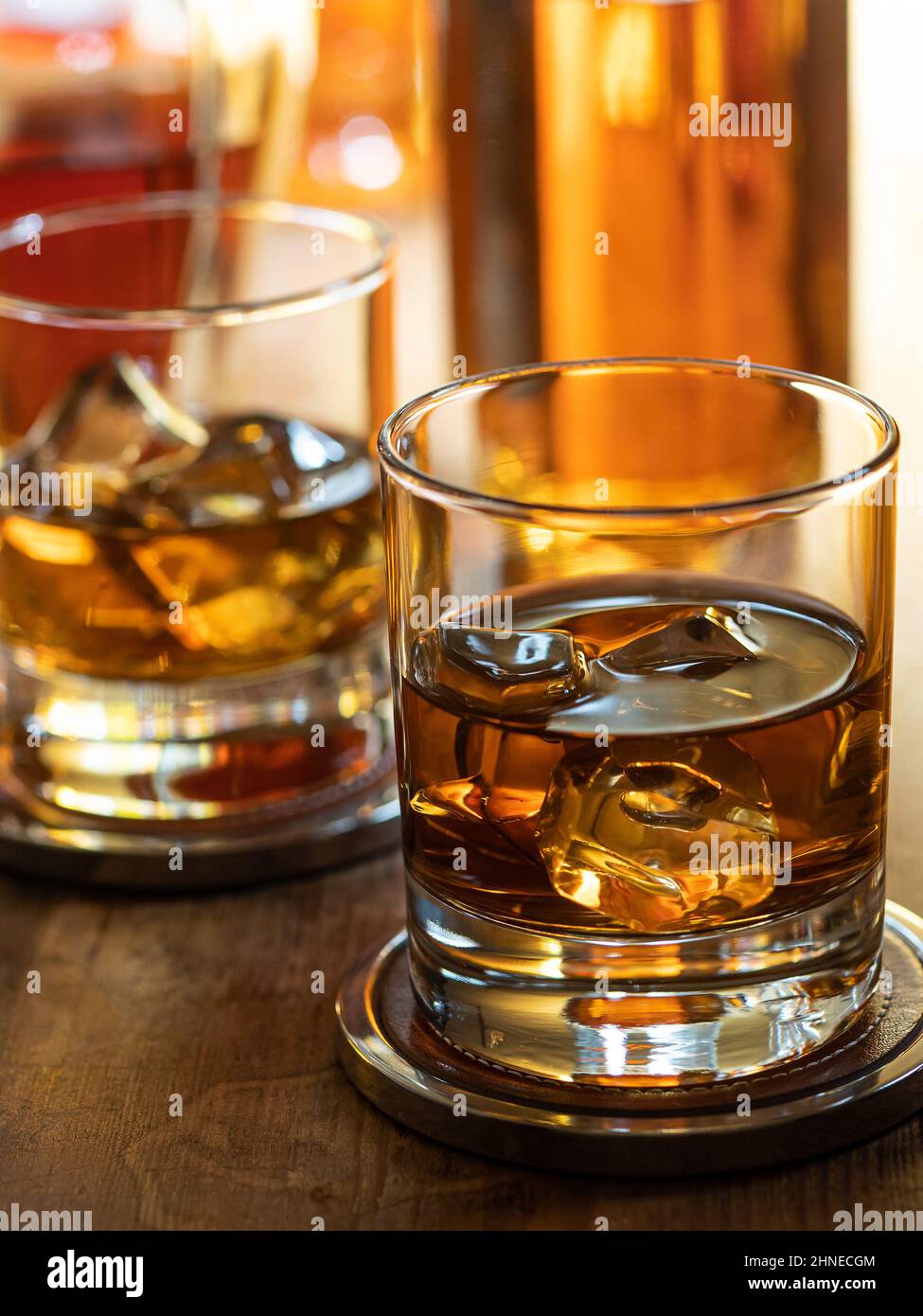 Glass of whisky on the rocks on a wooden bar top Stock Photo - Alamy