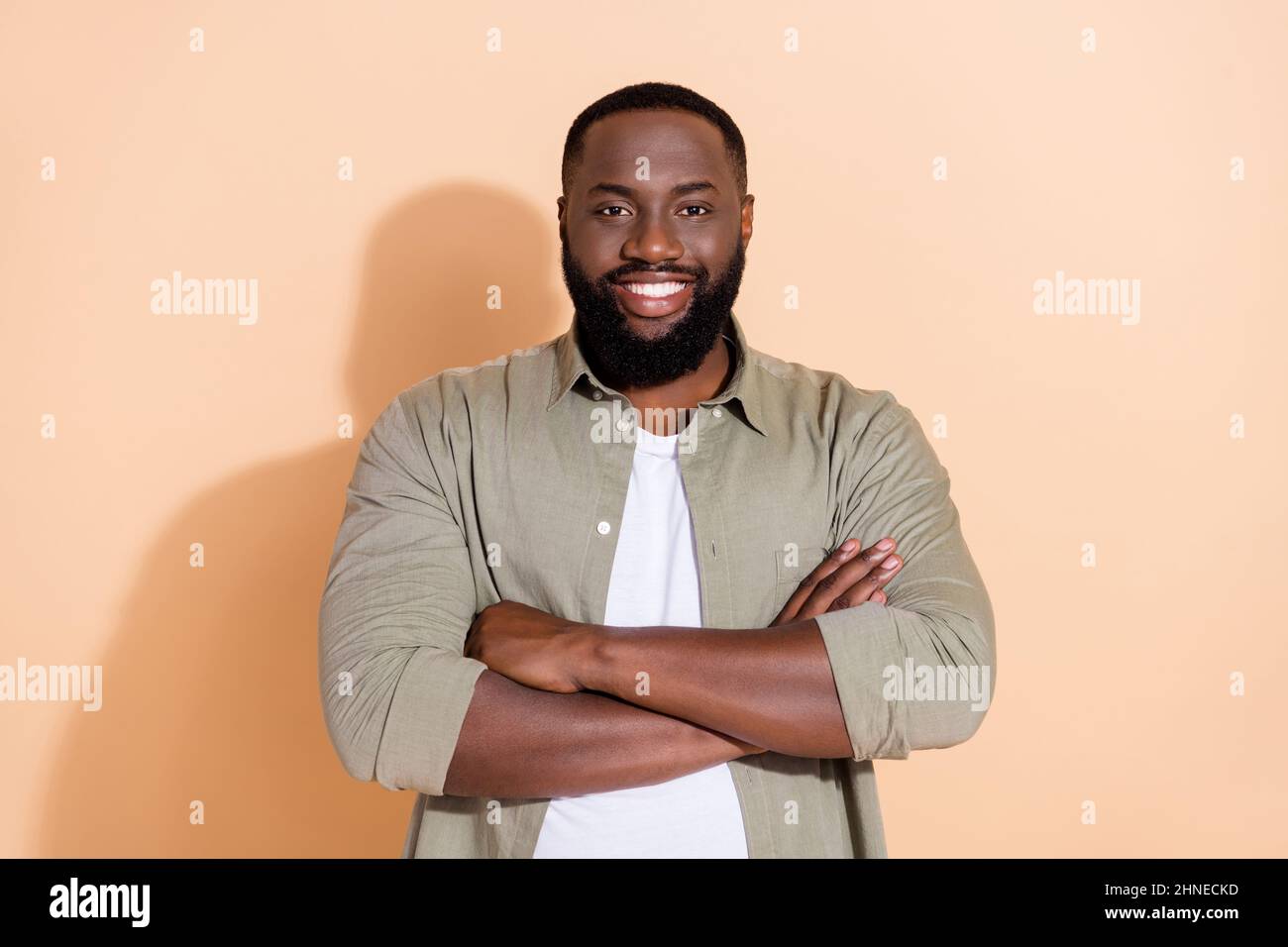 Photo of optimistic young beard ceo guy crossed palms wear grey outfit ...
