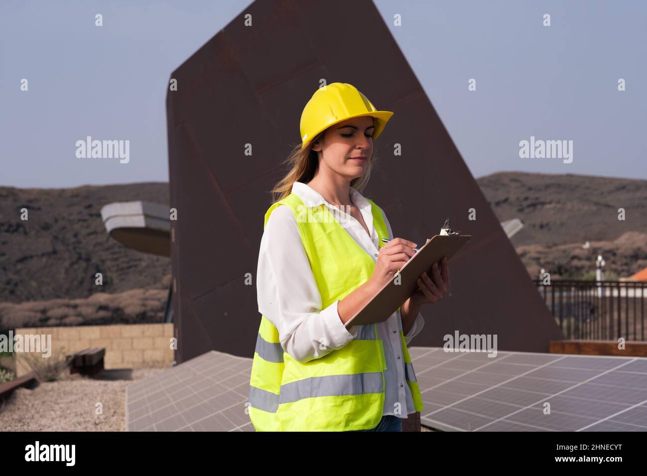 Engineer woman taking notes of renewable energies Stock Photo - Alamy