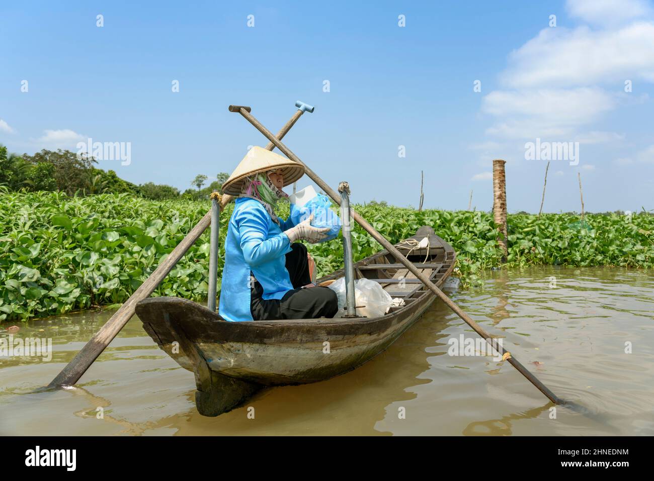 Vietnamese woman with a traditional wooden rowing boat (sampan) on the ...