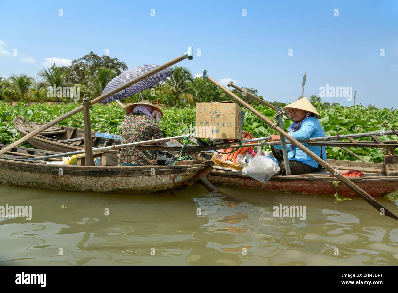 Vietnamese women with traditional wooden rowing / motor boats (sampans ...