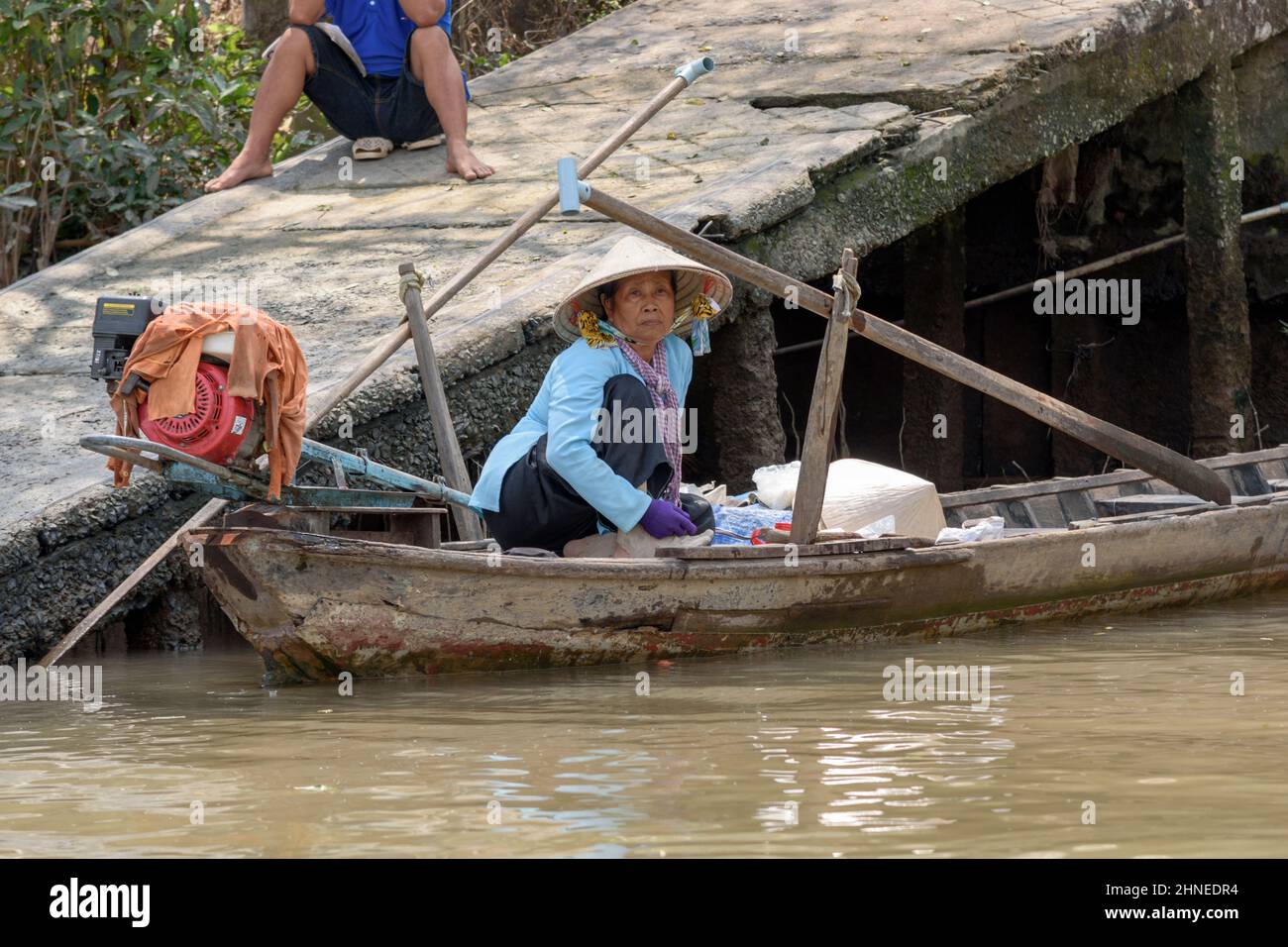 Vietnamese woman with a traditional wooden rowing / motor boat (sampan ...