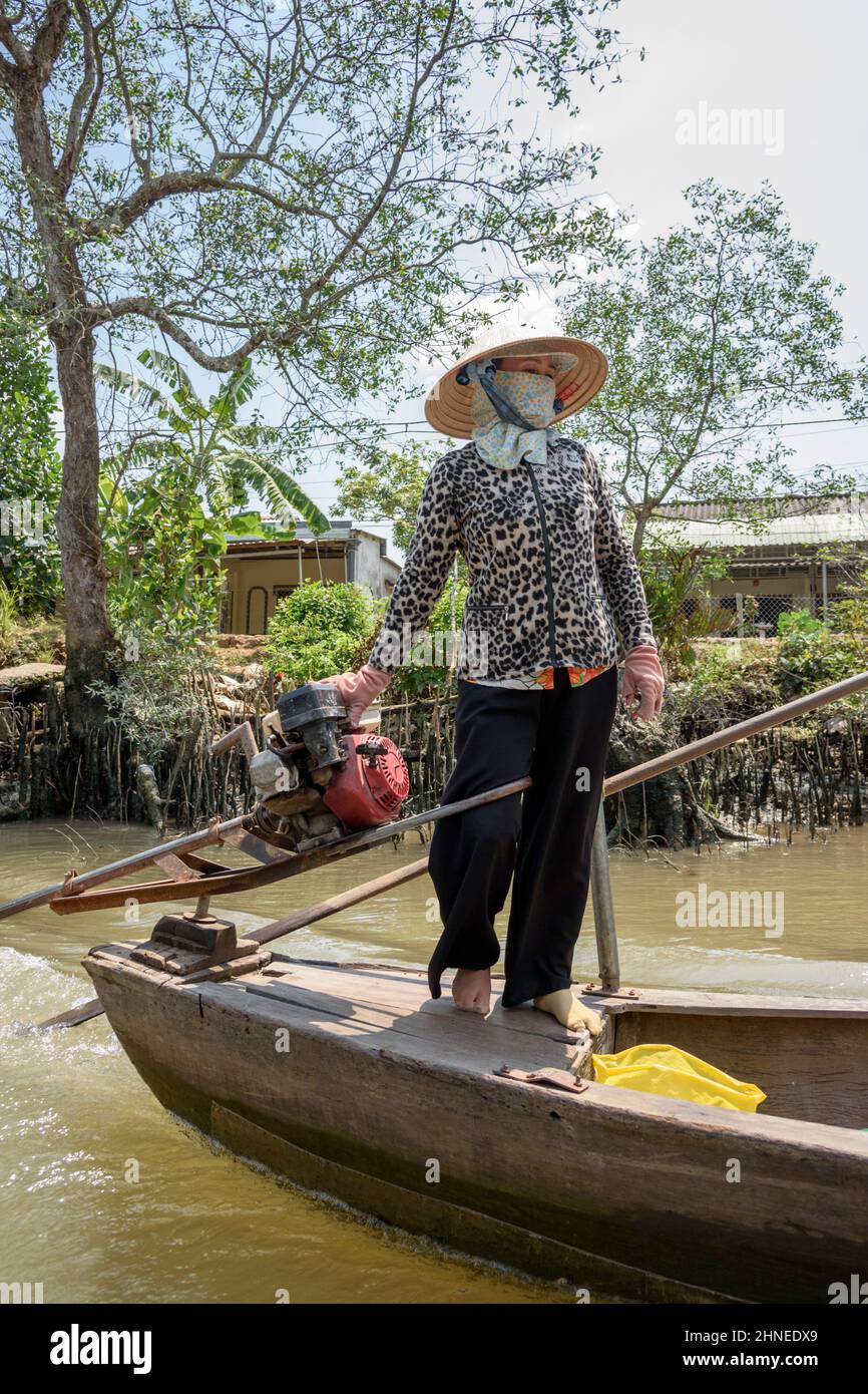 Vietnamese woman with a traditional wooden rowing / motor boat (sampan ...