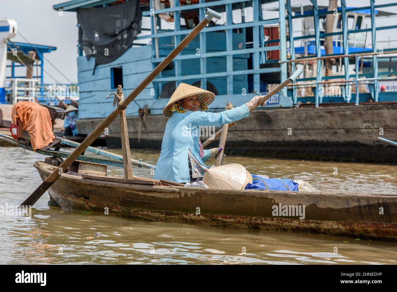 Vietnamese woman with a traditional wooden rowing / motor boat (sampan ...