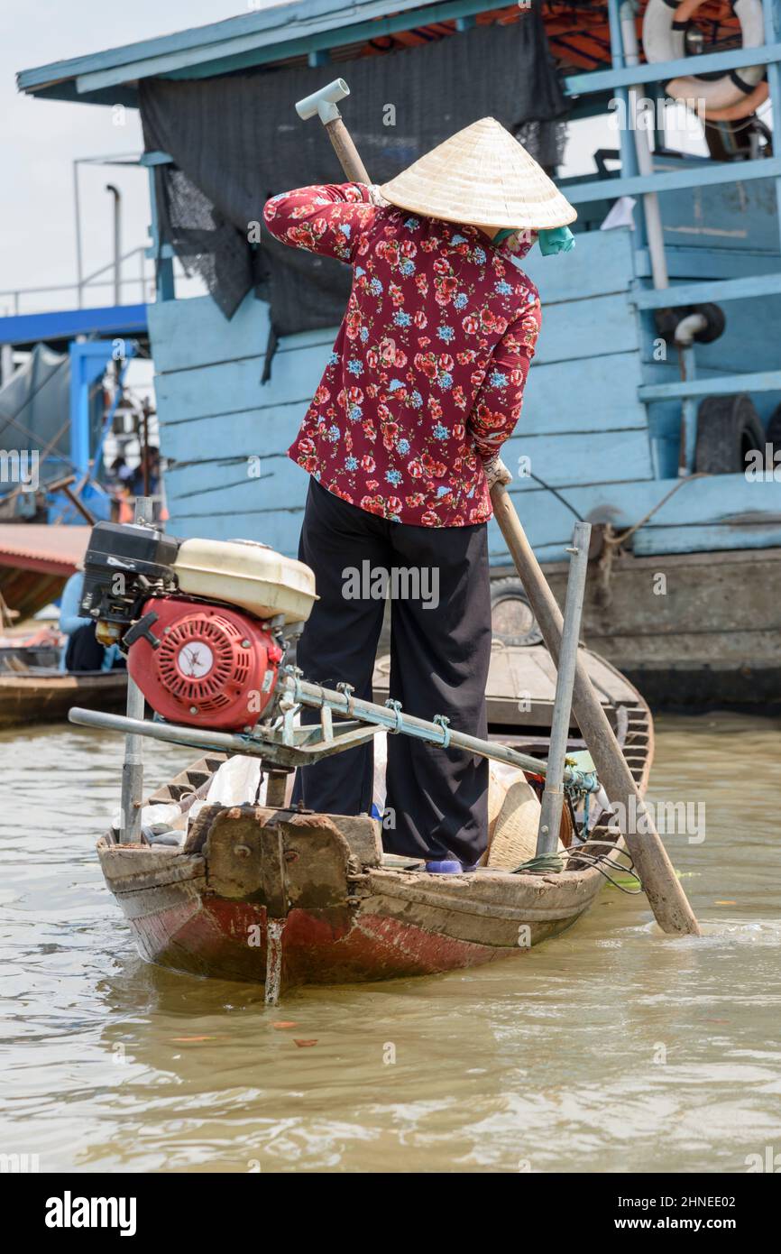 Vietnamese woman with a traditional wooden rowing / motor boat (sampan ...