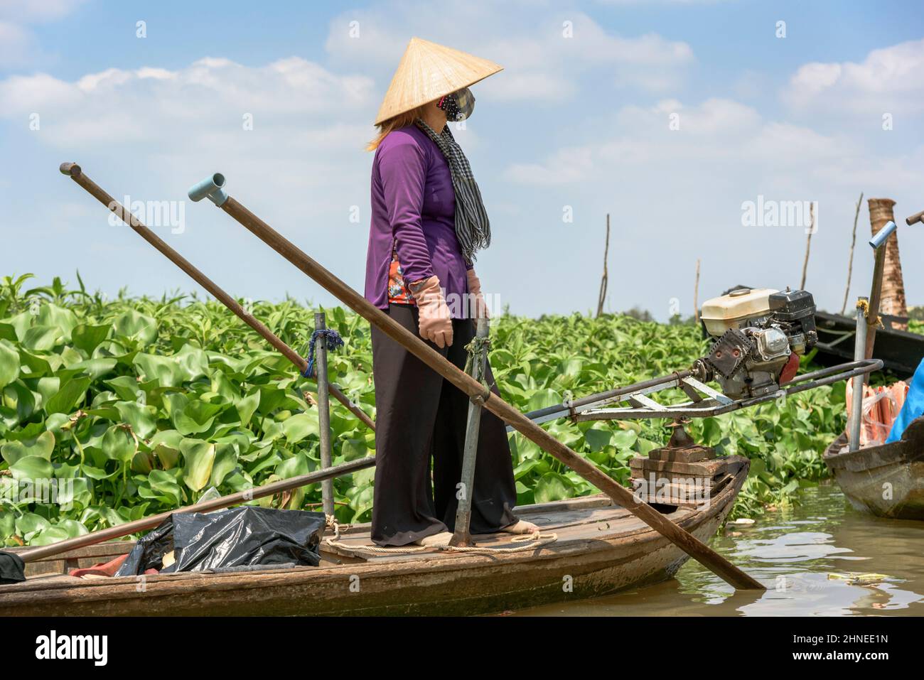 Vietnamese woman with a traditional wooden rowing / motor boat (sampan ...