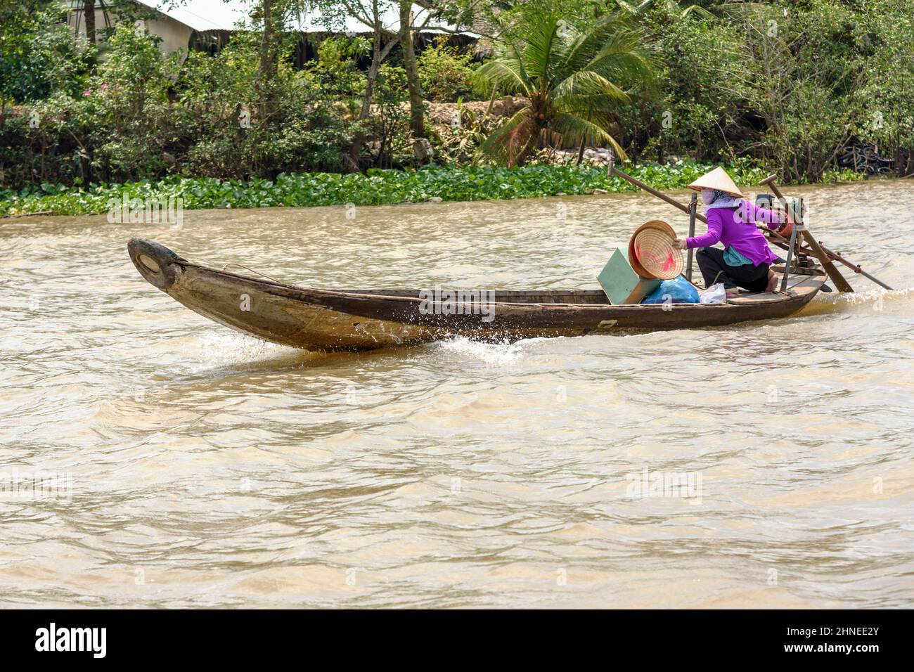 Vietnamese woman with a traditional wooden motor boat (sampan) on the ...