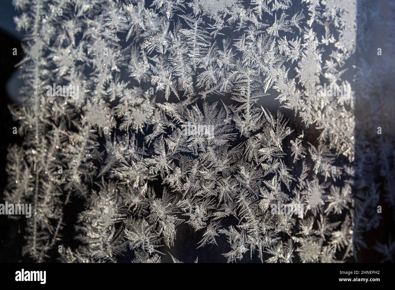 Melting ice running down a window pane, Closeup of frozen window pane ...