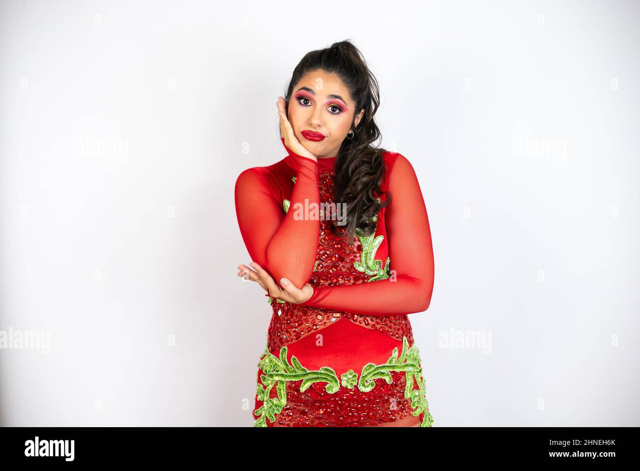 Young beautiful woman wearing carnival costume over isolated white ...