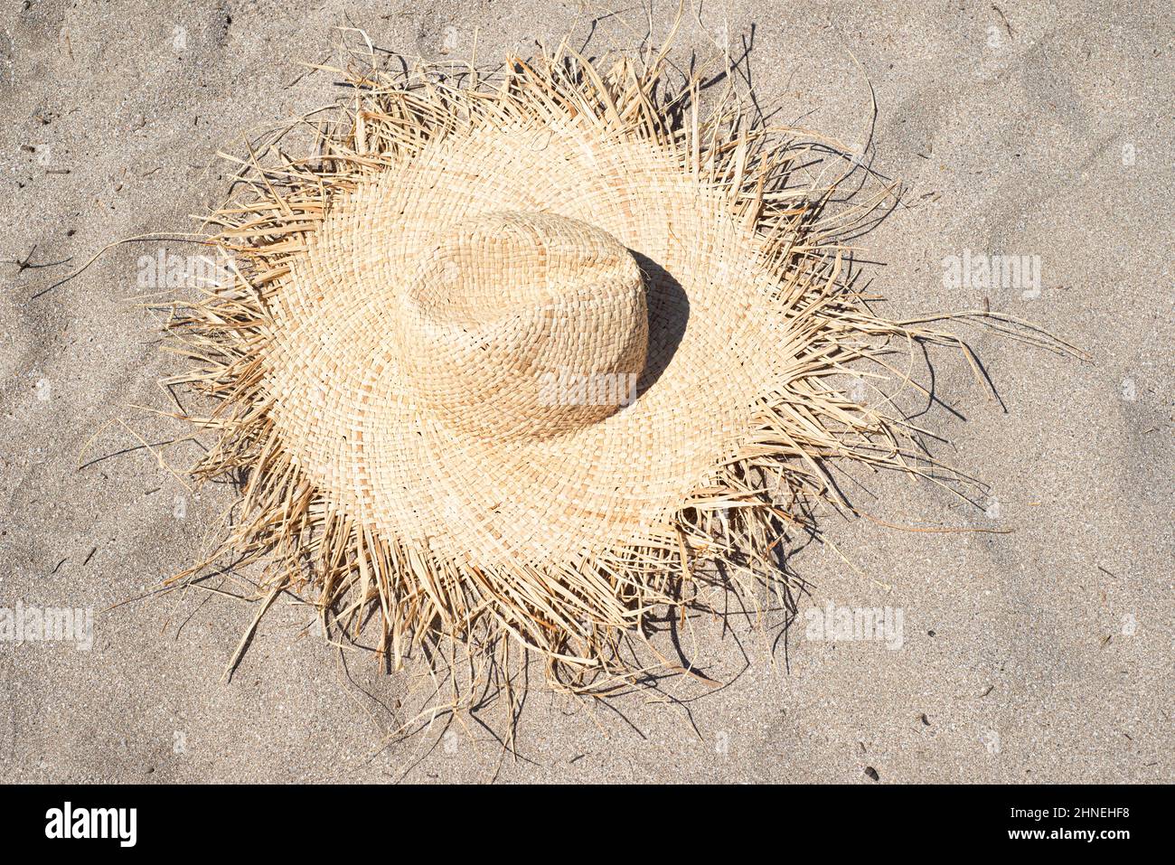 Straw hat on the beach sand. Beach backgrounds. Sun protection. Rest ...