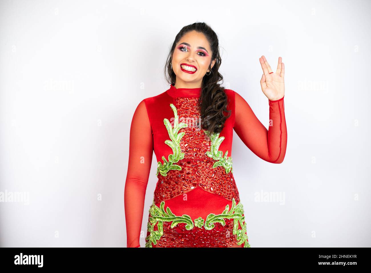 Young beautiful woman wearing carnival costume over isolated white ...