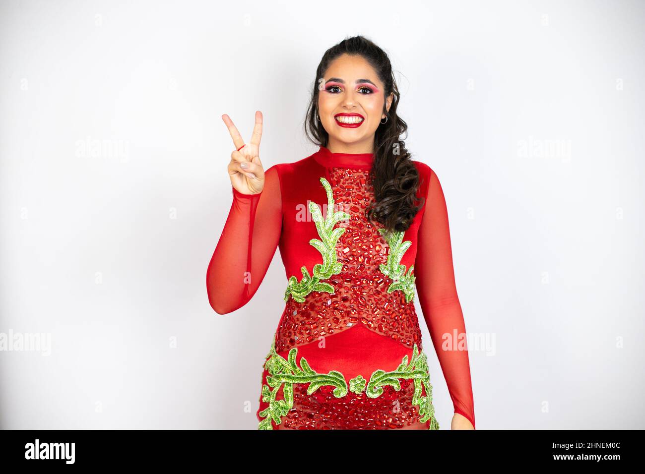Young beautiful woman wearing carnival costume over isolated white ...