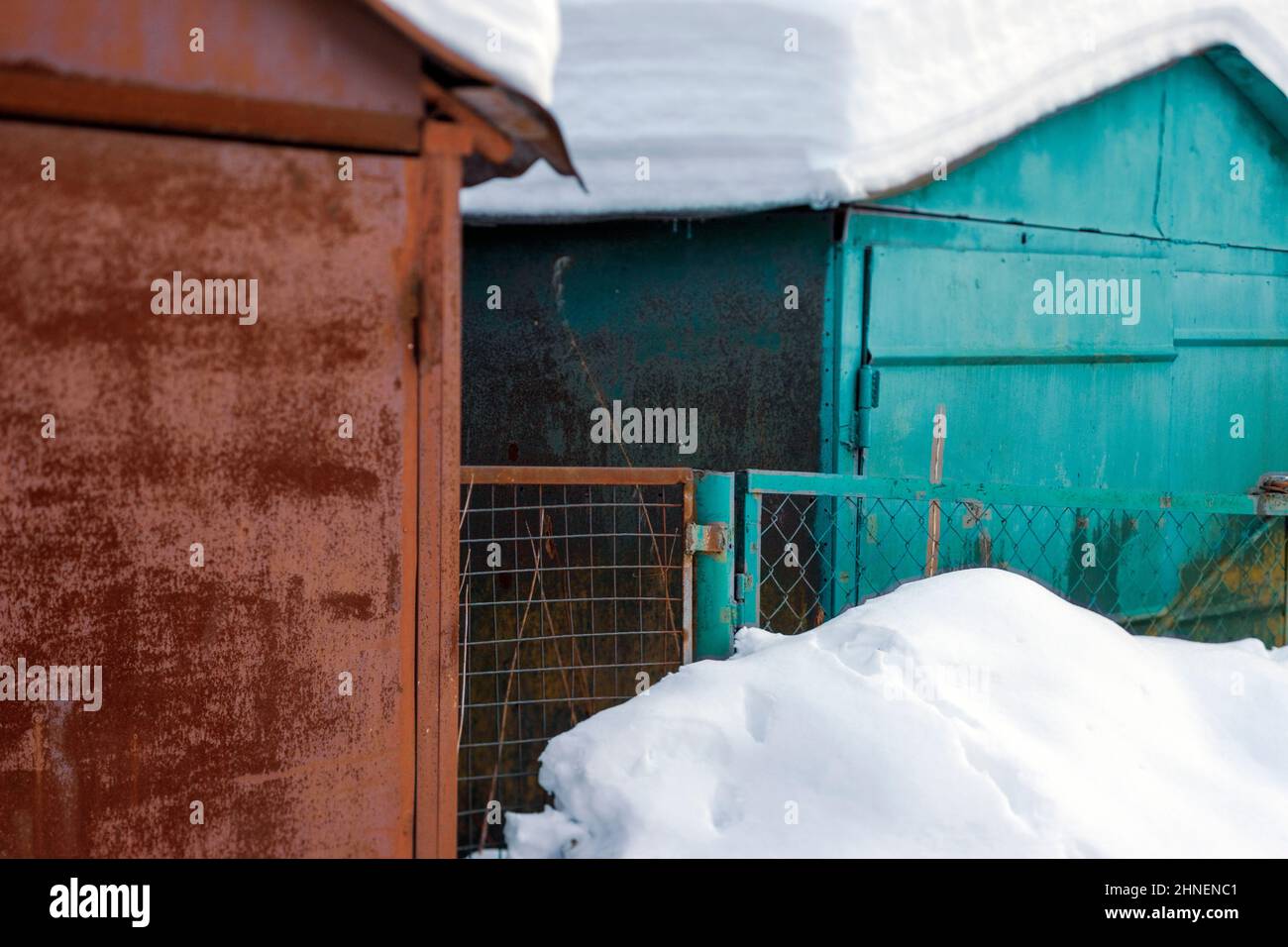 two derelicted metal garages, covered with snow, a winter scene Stock ...