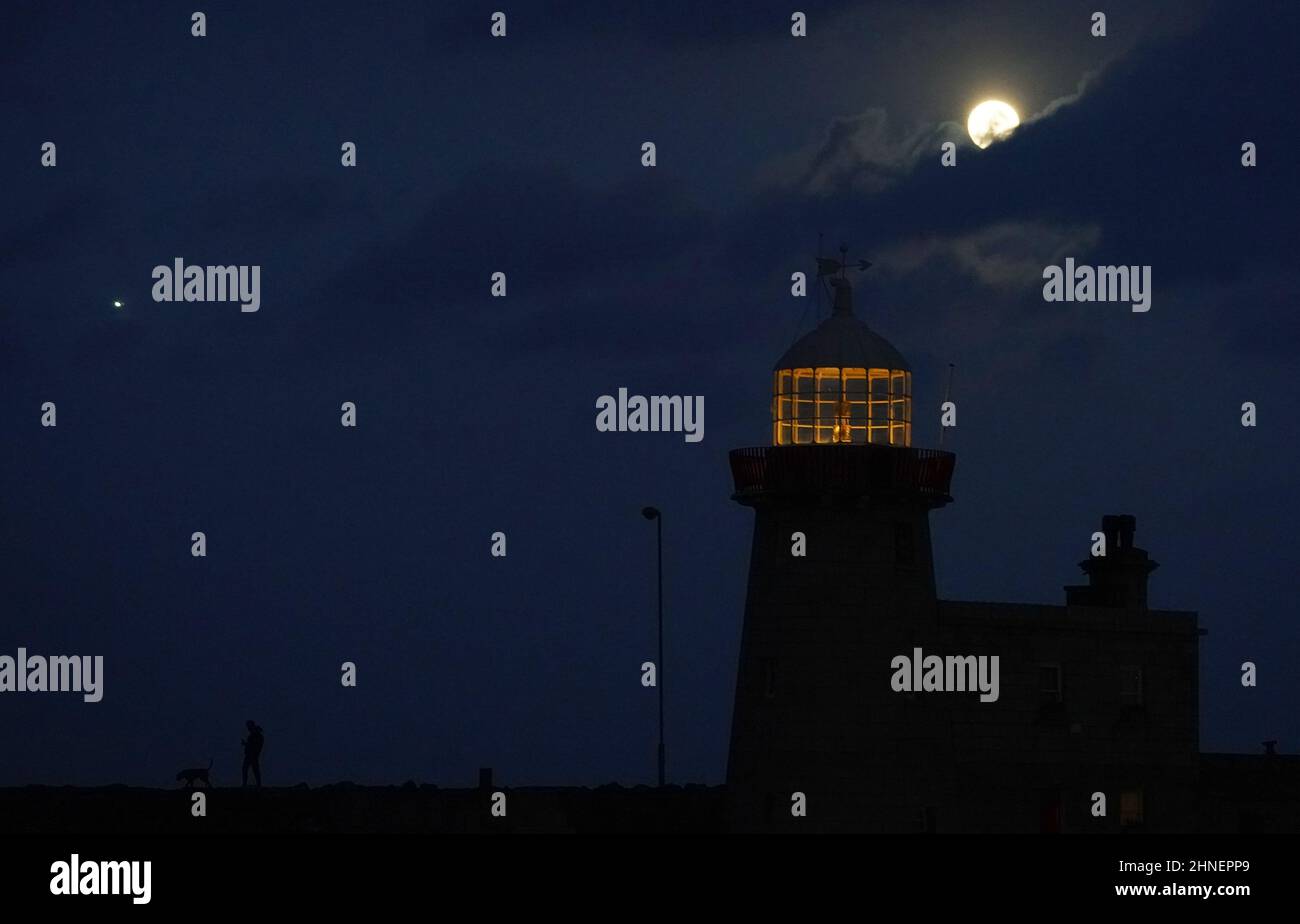 The full moon known as the 'Snow moon' rises above Howth lighthouse in ...