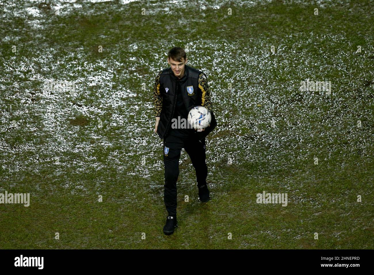 Ciaran Brennan #34 of Sheffield Wednesday inspects the water logged ...