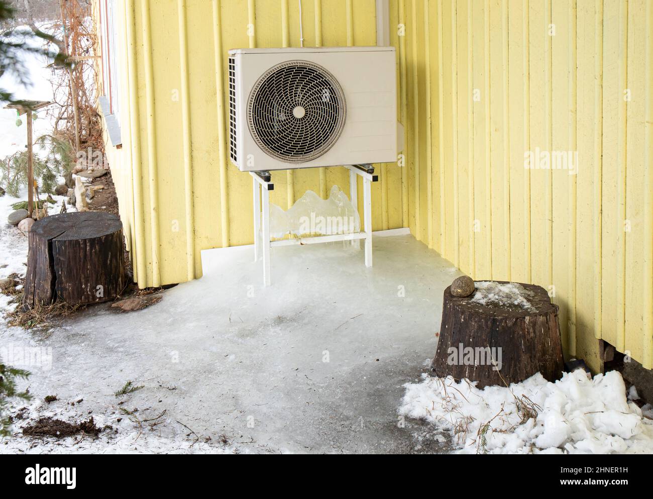 Air conditioner machine outdoors on rack on domestic home house yellow ...